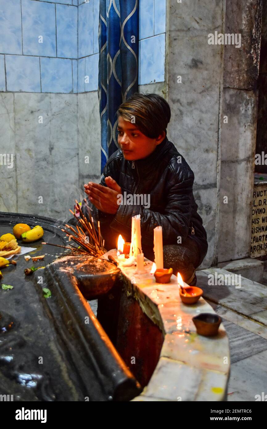 A devotee seen praying at a temple during the occasion. The festival of ...