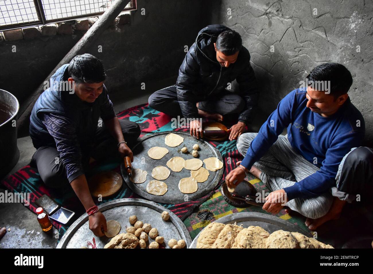 Workers seen preparing food for devotees at a temple during the ...