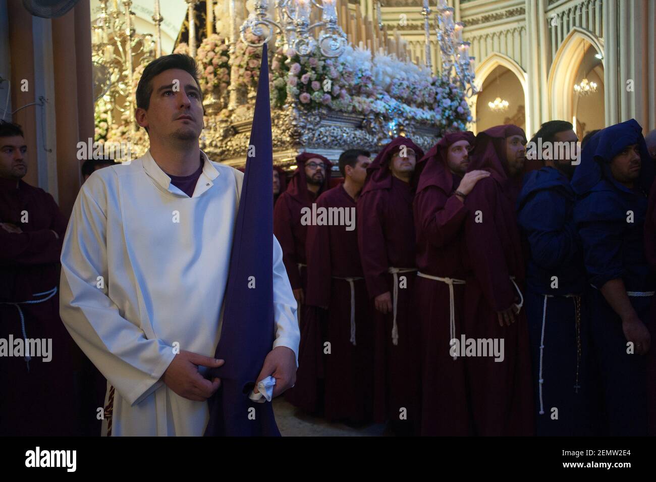 A penitent of 'Salud' brotherhood is seen crying inside a church as he ...