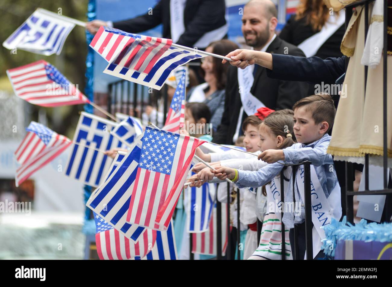 Young participants seen holding flags of Greece and USA during the ...