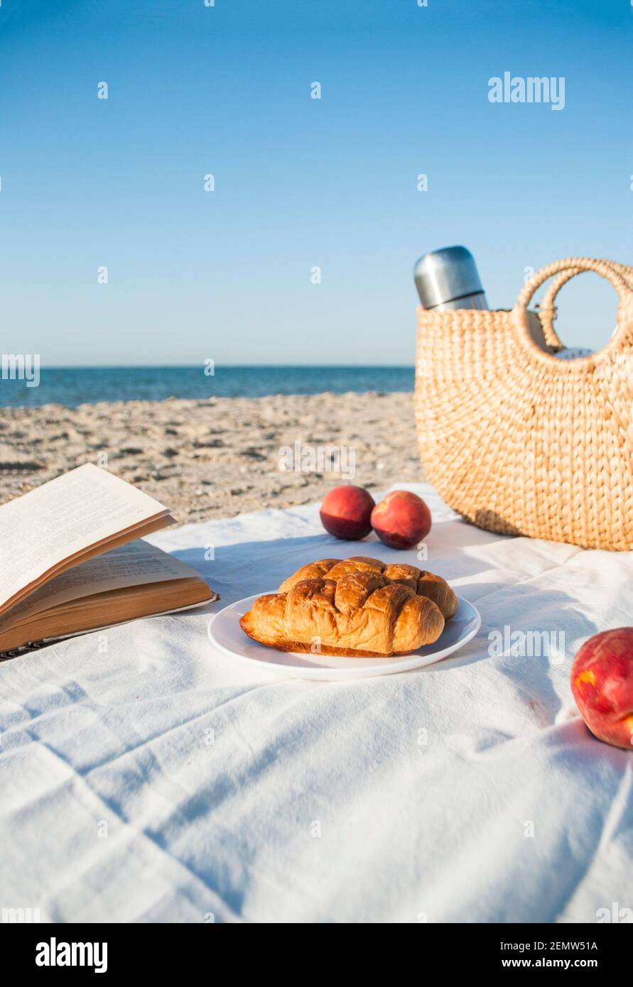 Cozy atmospheric picnic at the seaside with fresh croissants and an ...