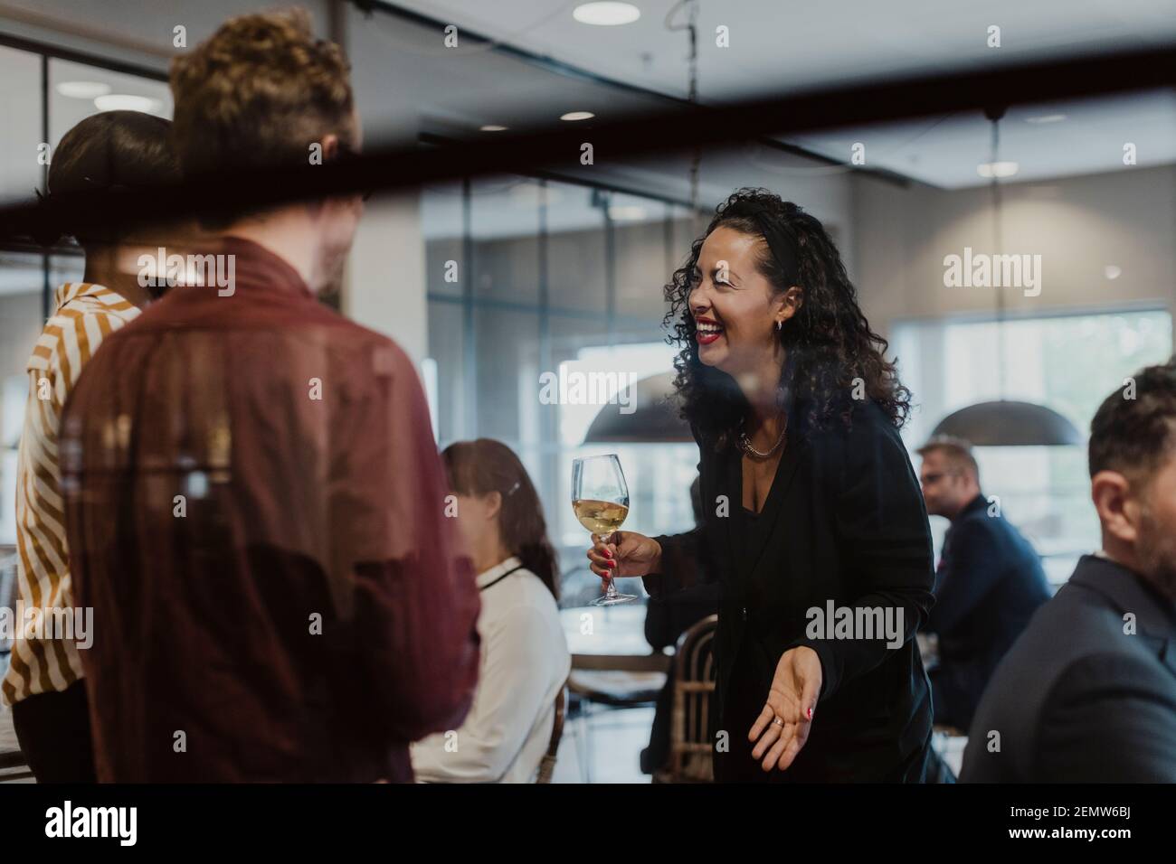 Female executive talking colleague during hi-res stock photography and ...