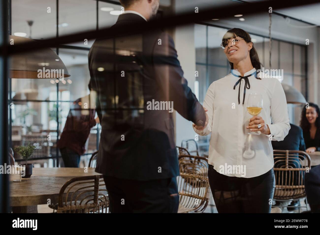 Woman shaking hands party hi-res stock photography and images - Alamy