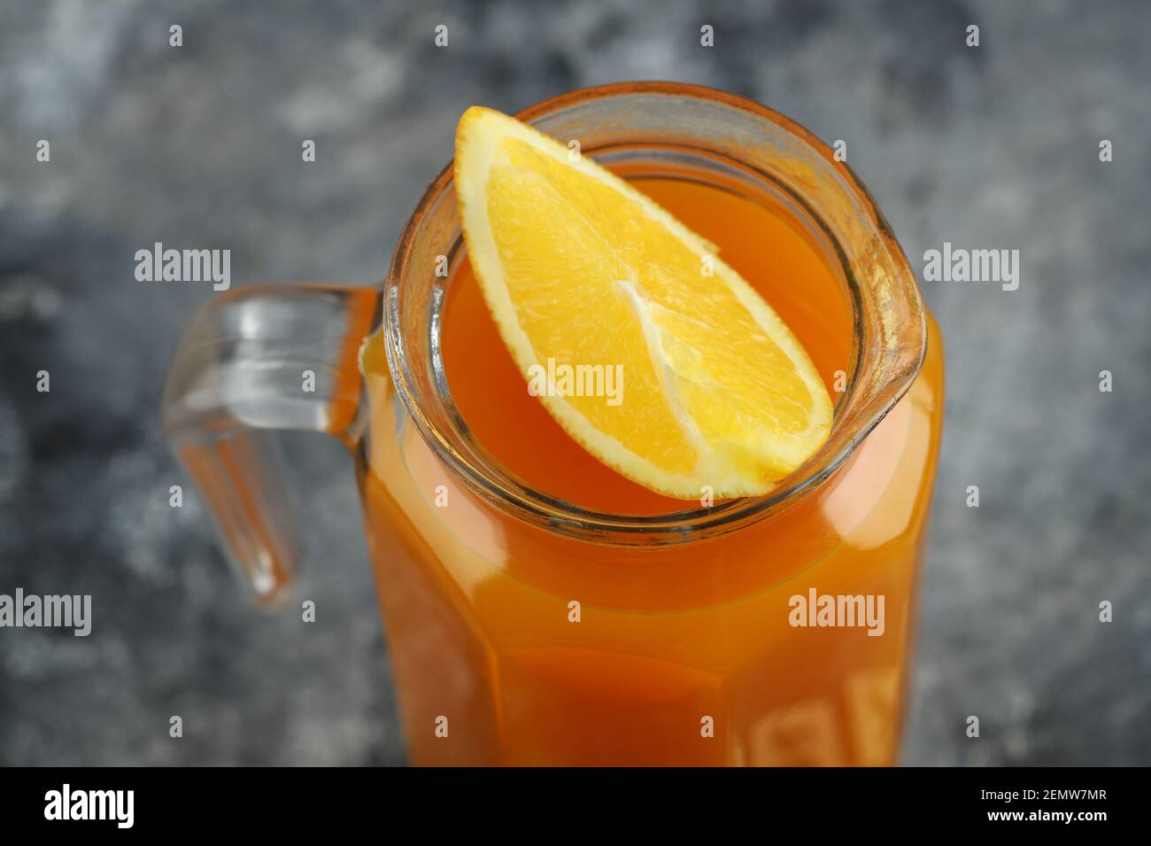 Pure fruit juice with orange slice on marble background Stock Photo - Alamy