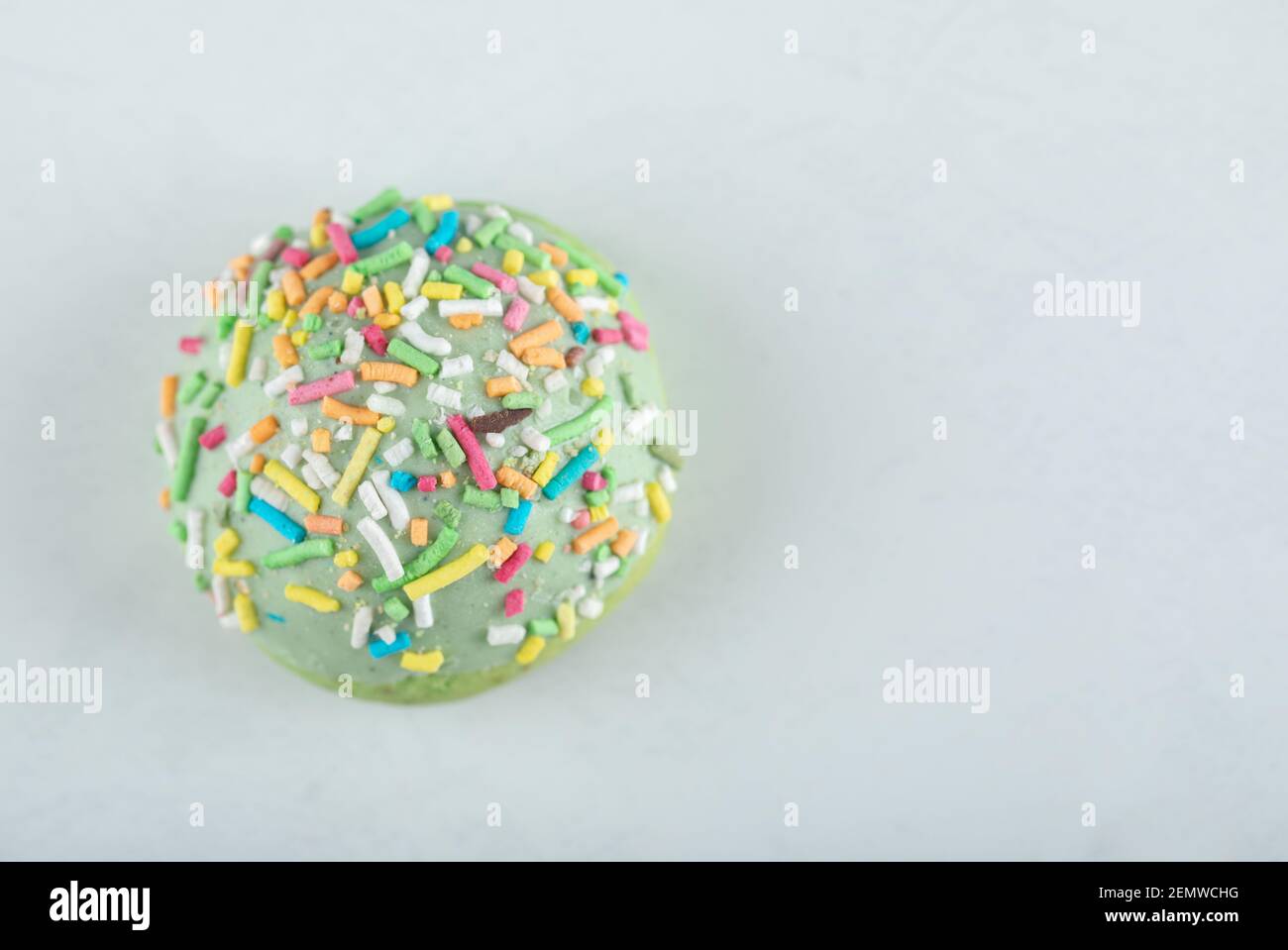 Green cookie with sprinkles on white background Stock Photo - Alamy