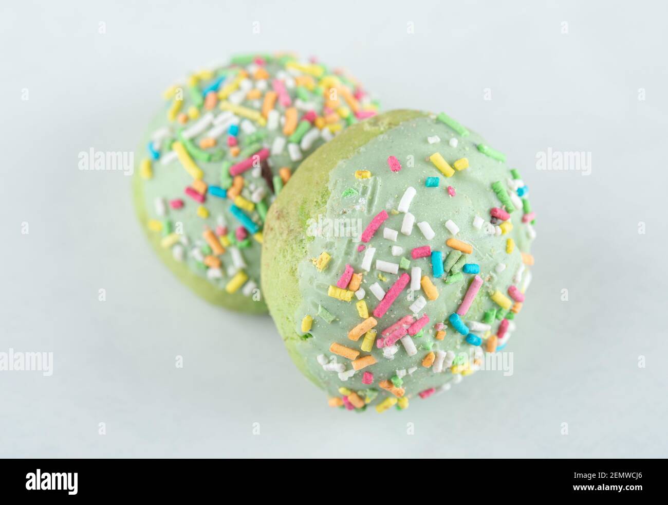 Green cookies with sprinkles on white background Stock Photo - Alamy