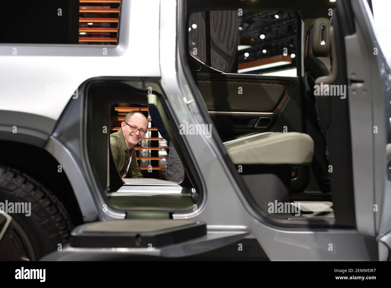 Patrick Hunt, Rivian Strategy Director, smiles as he looks through the "gear tunnel" of the ...