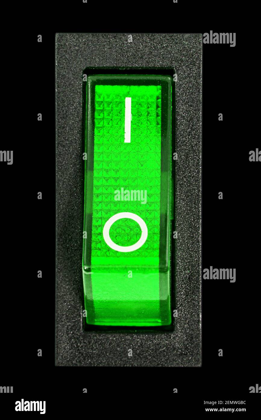 Green power switch at ON position, isolated on black background Stock ...