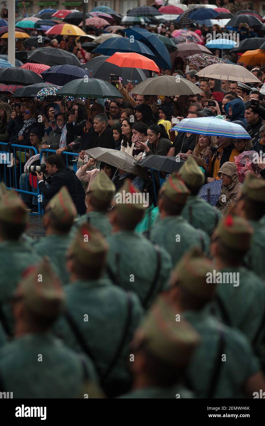 Spanish legionnaires and spectators with umbrellas are seen attending ...