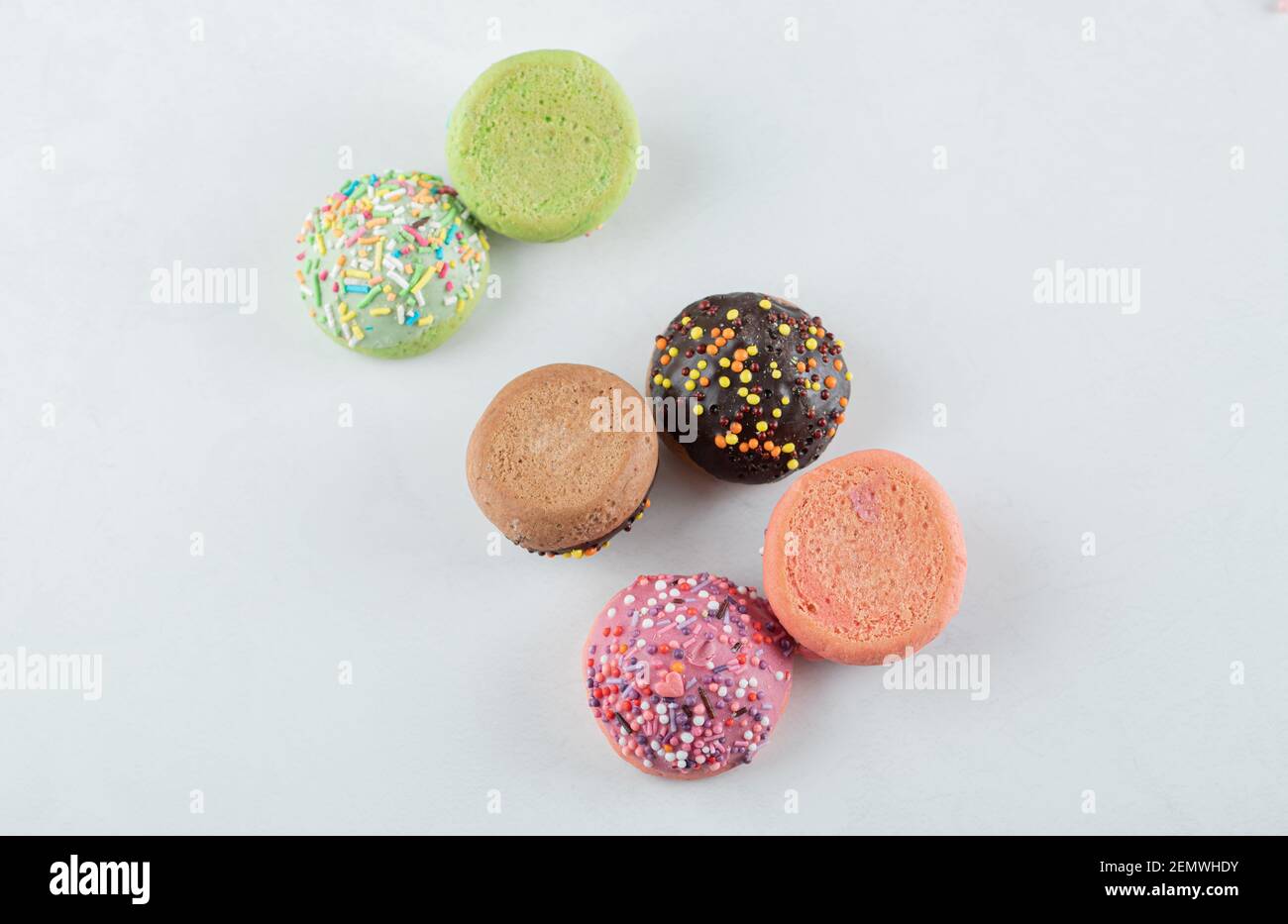 Colorful cookies with sprinkles on white background Stock Photo - Alamy