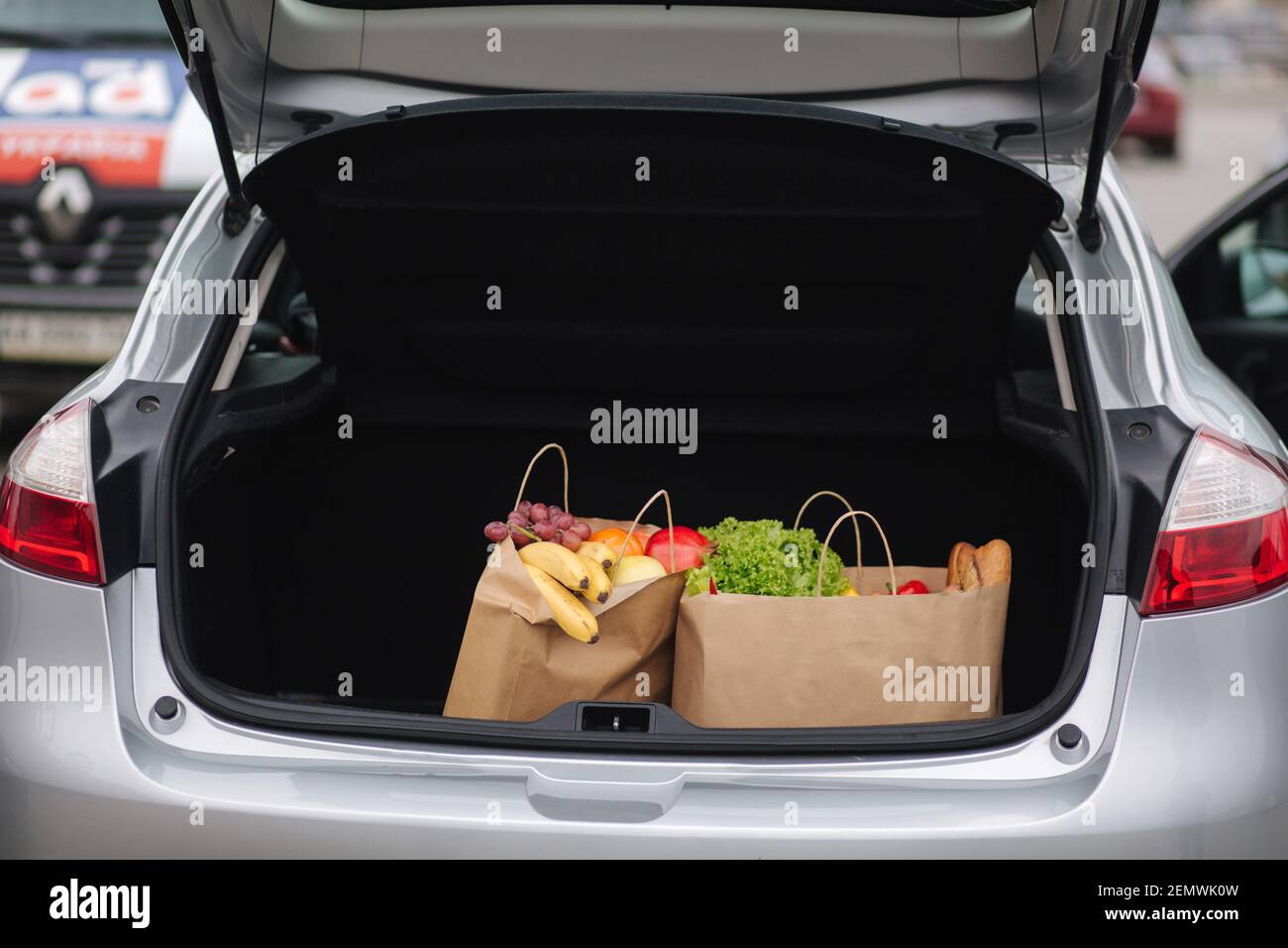 Groceries from a supermarket in a car trunk. Food delivery during ...