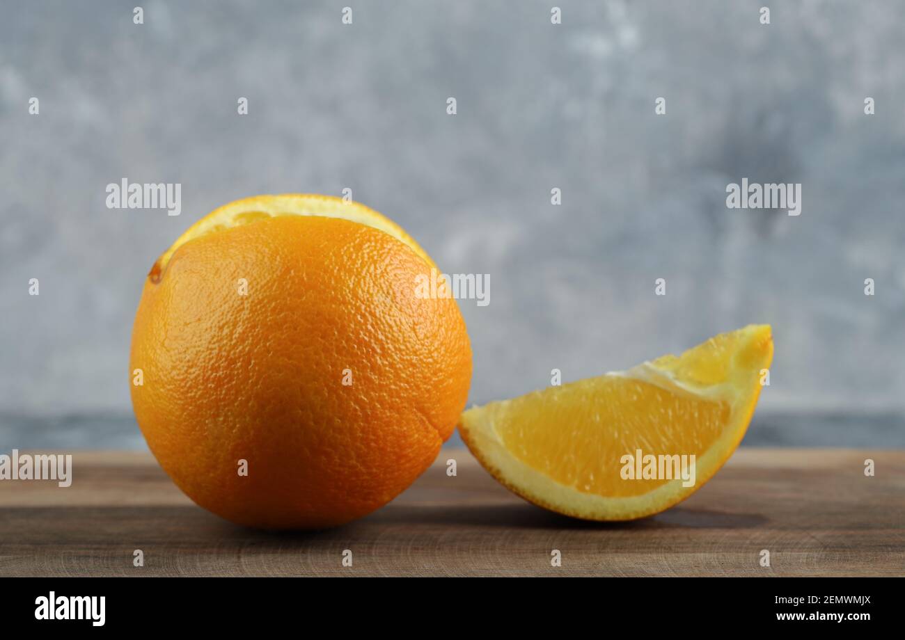 Whole and sliced orange on marble background Stock Photo - Alamy