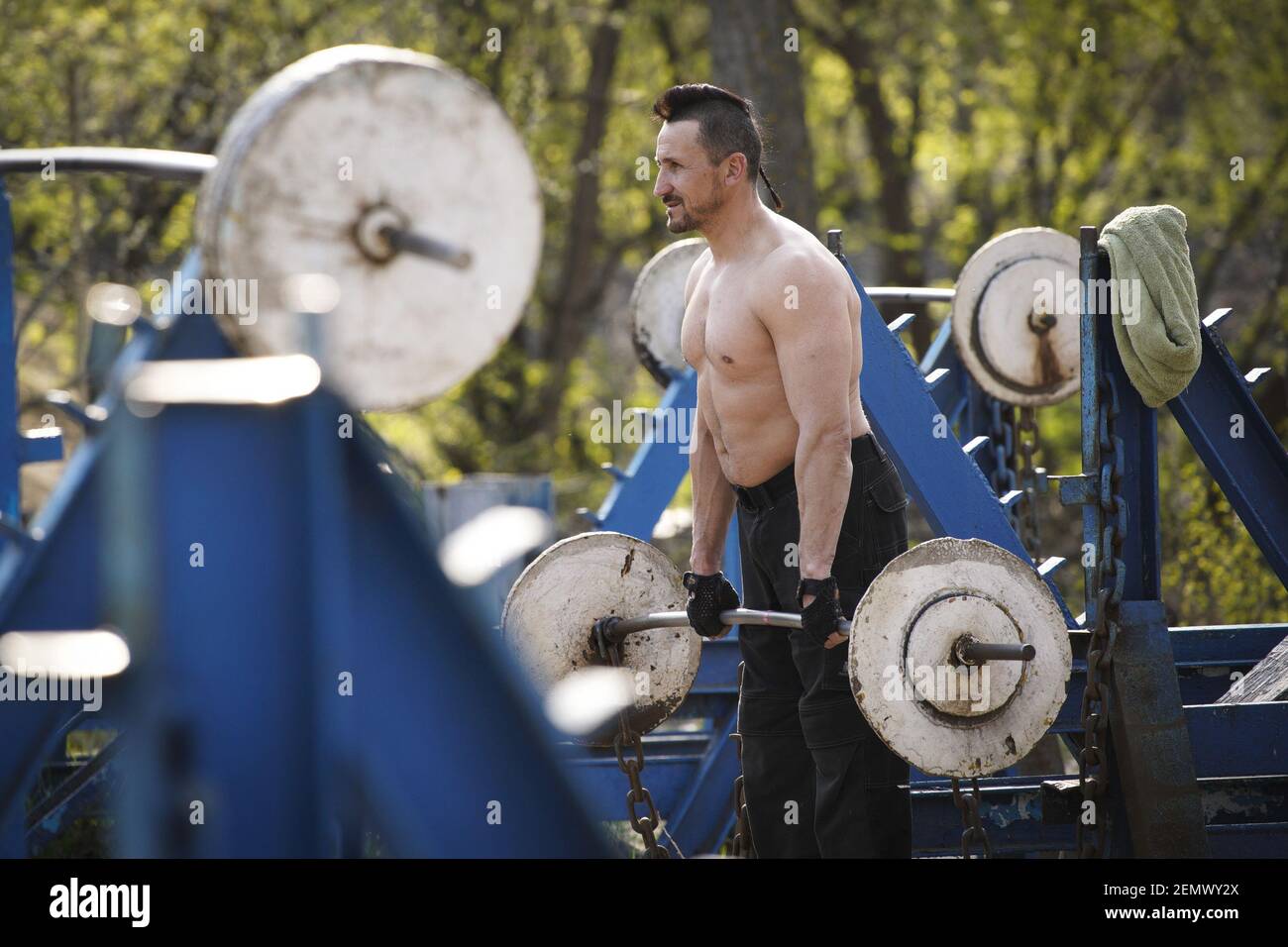 A man is seen exercising at the Kachalka outdoor scrapyard gym in Kyiv ...