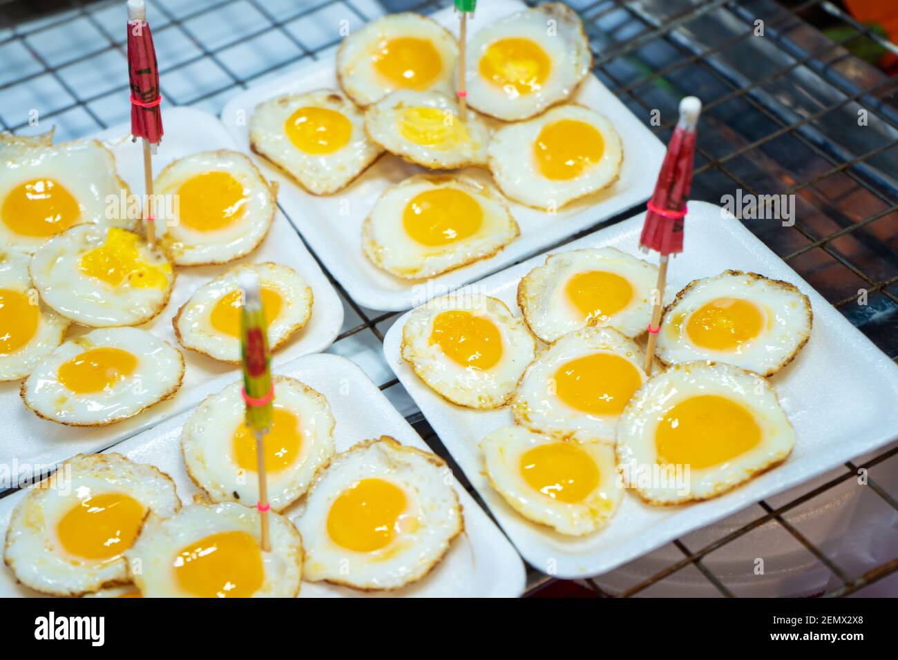 street food in Thailand. Fried eggs. Scrambled eggs for take away Stock ...