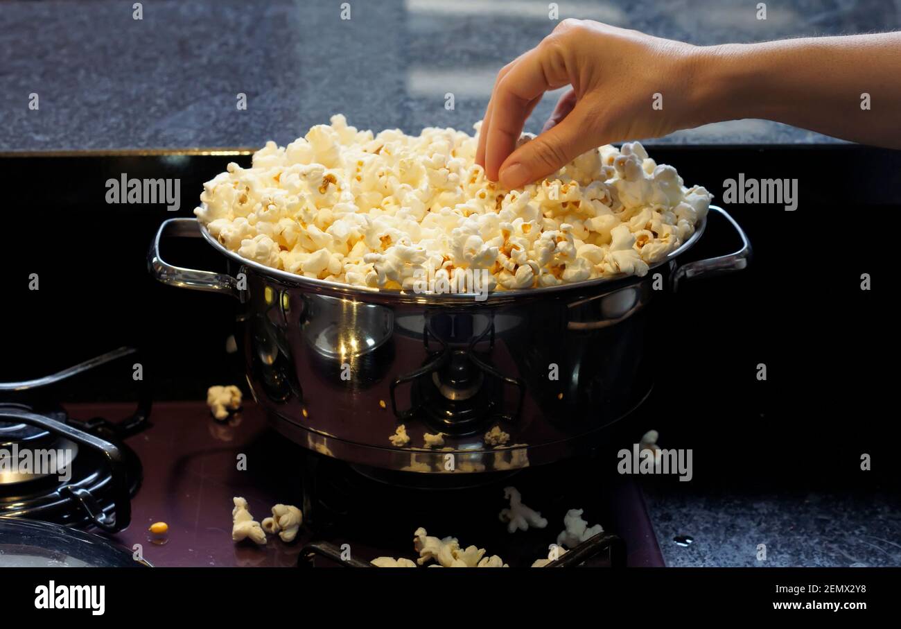A stainless pan full of popcorn. Photo focus in the middle of the ...