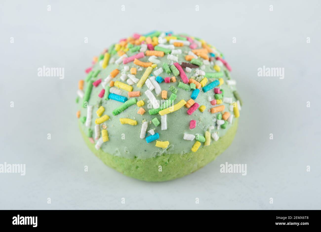 Green cookie with sprinkles on white background Stock Photo - Alamy