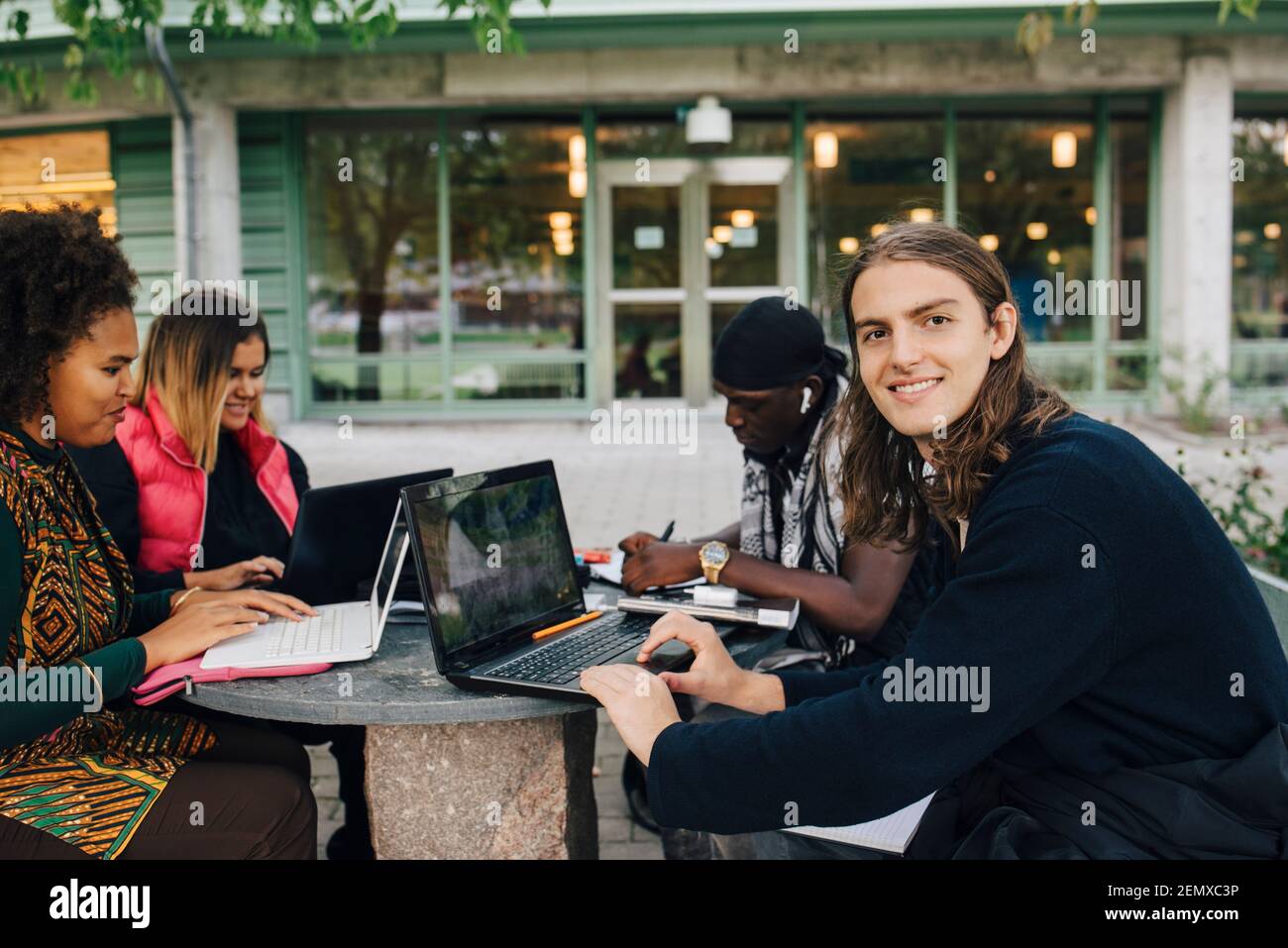 Smiling university student studying in college Stock Photo - Alamy