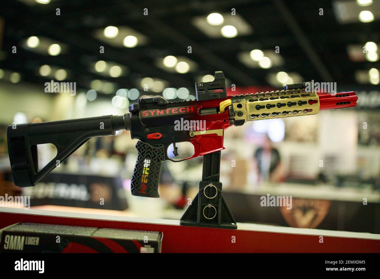 A rifle is on display at the NRA convention. Vendors prepare booths in ...