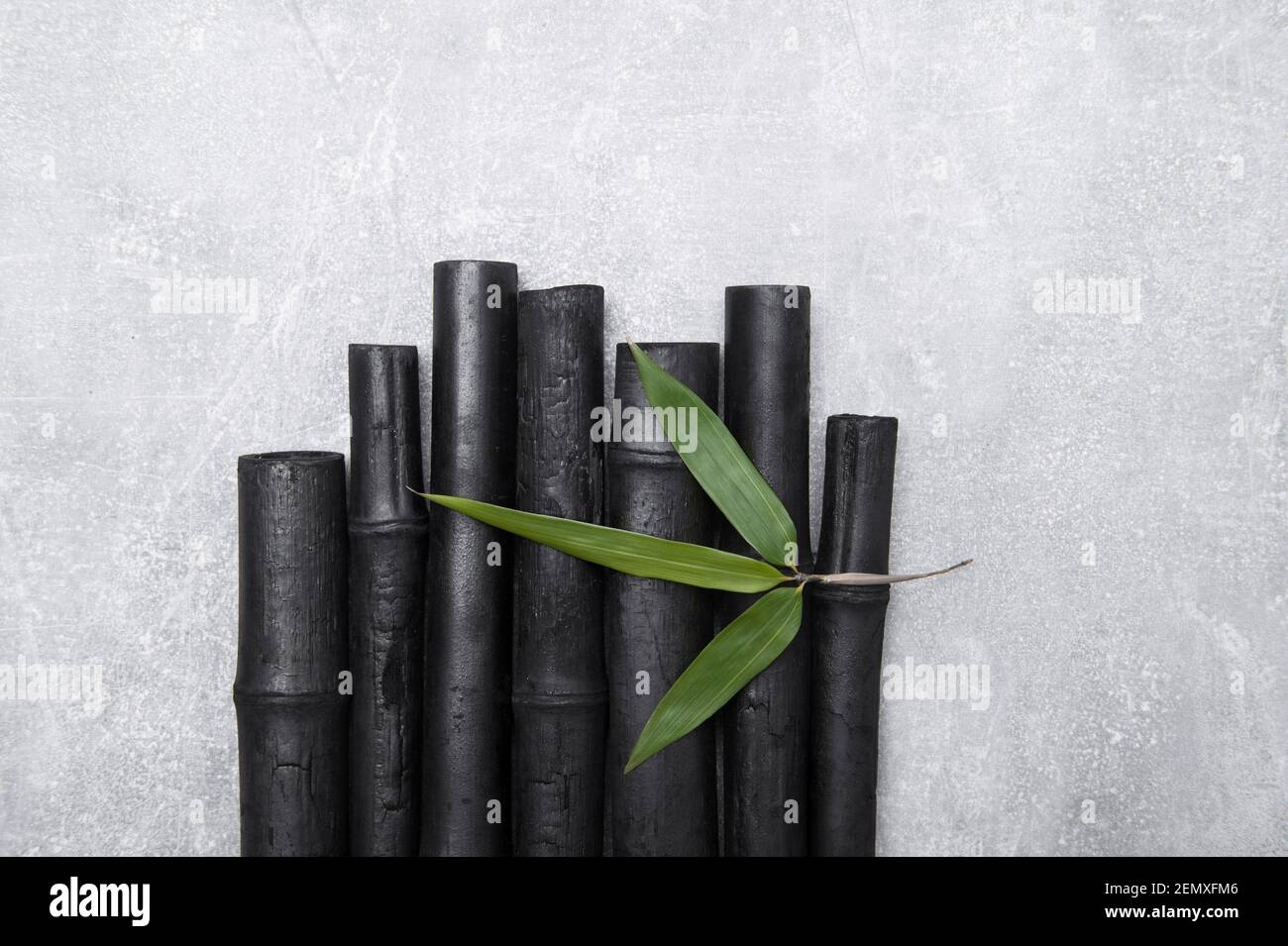 Natural activated bamboo charcoal on concrete background. Realistic ...
