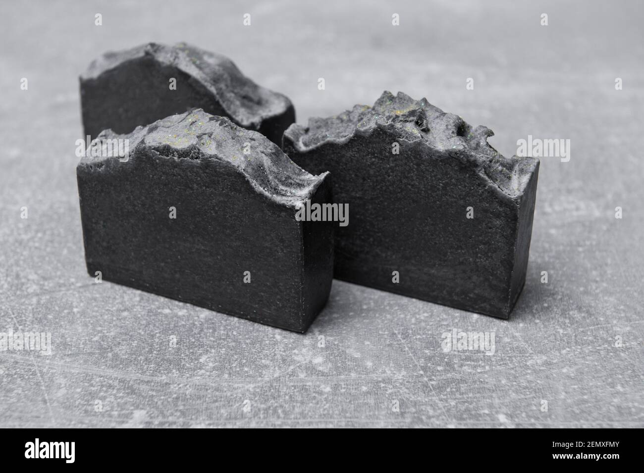 Soap bars handmade from natural charcoal on grey background Stock Photo ...