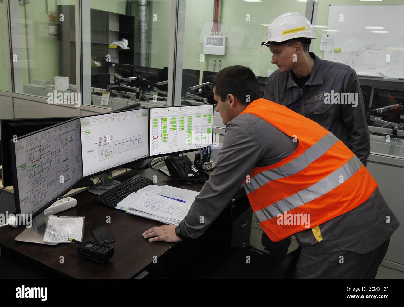Workers seen inside a central control room of the New Safe Confinement ...