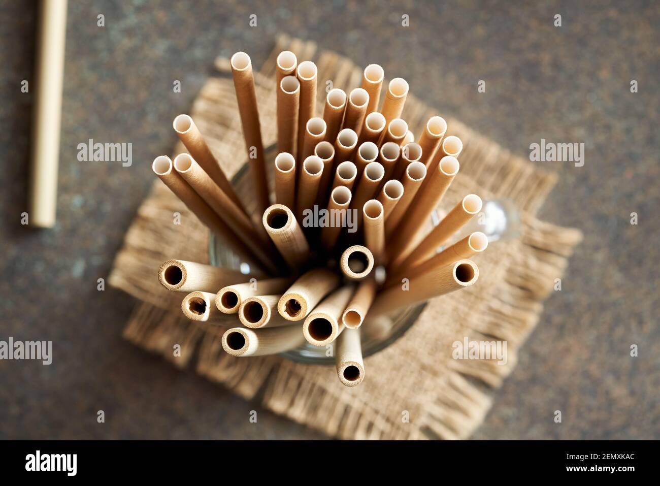 Bamboo and paper straws in a glass on a table, top view - zero-waste or ...
