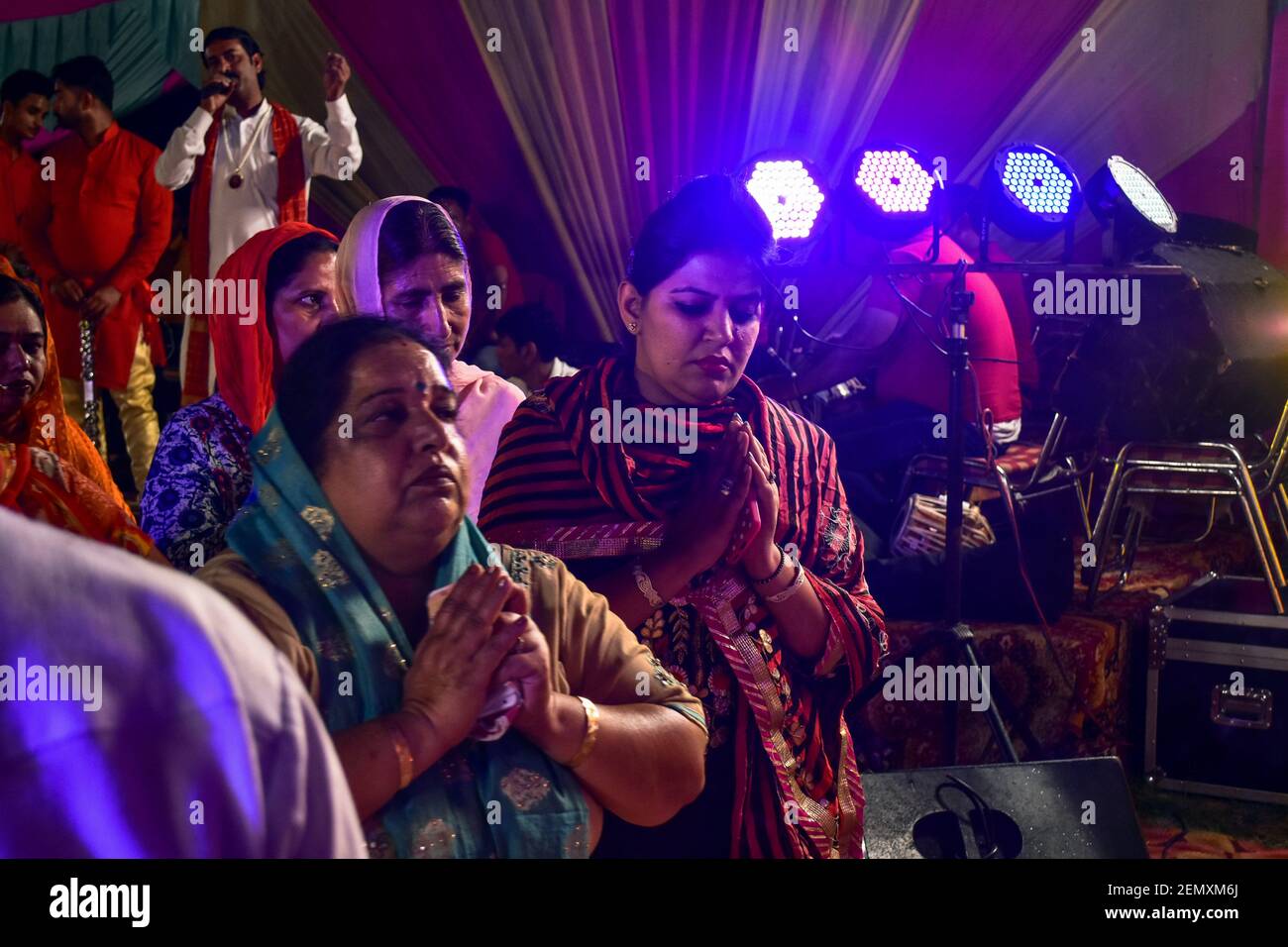 Devotees seen praying during the ritual. Jagran is a Hindu ritual ...
