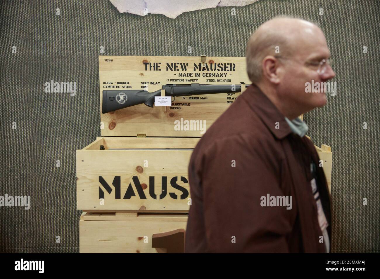 An NRA member stands near the Mauser gun booth during the third day of ...