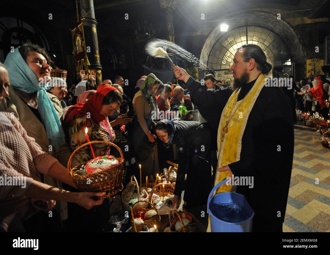 An Orthodox priest seen blessing the traditional Easter cakes and ...