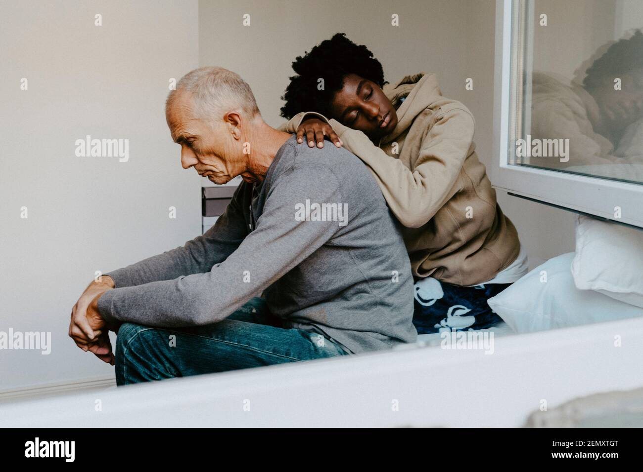 Stressed father and daughter sitting in bedroom Stock Photo - Alamy