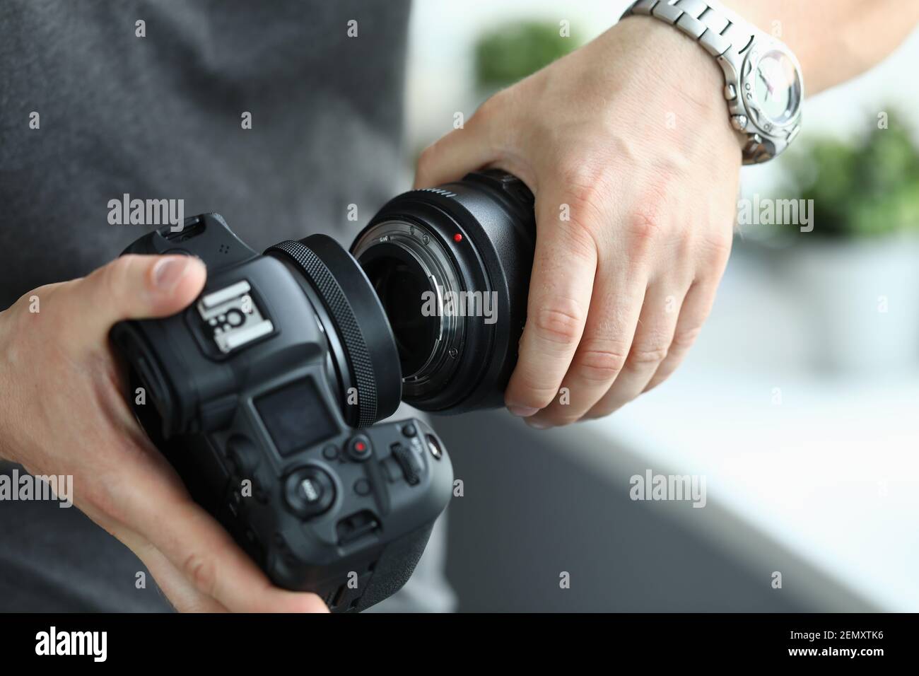 Male hands putting on modern digital camera professional lens Stock ...