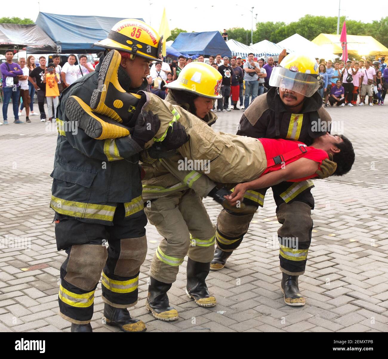 Participating firefighters are seen carrying a wounded patient during a ...