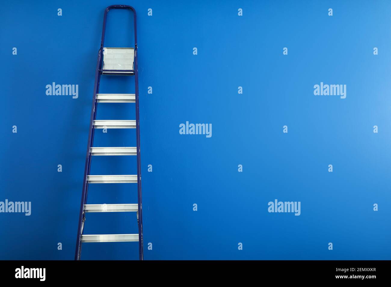 High metal ladder leaning against the wall Stock Photo - Alamy