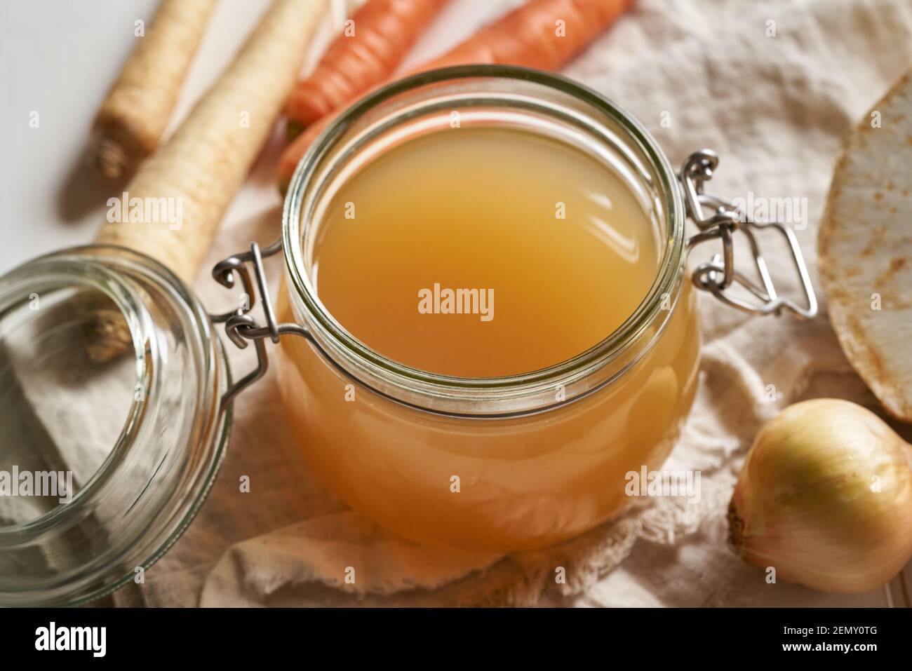 A jar of beef bone broth on a table Stock Photo - Alamy