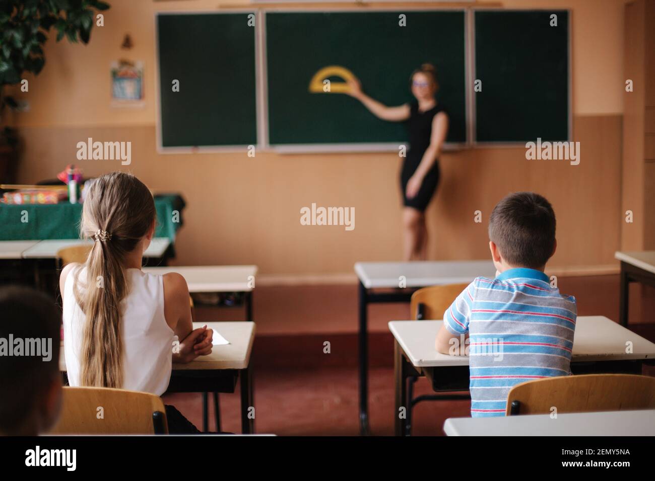 Back view of children sitting in the class room and study. Elementary ...