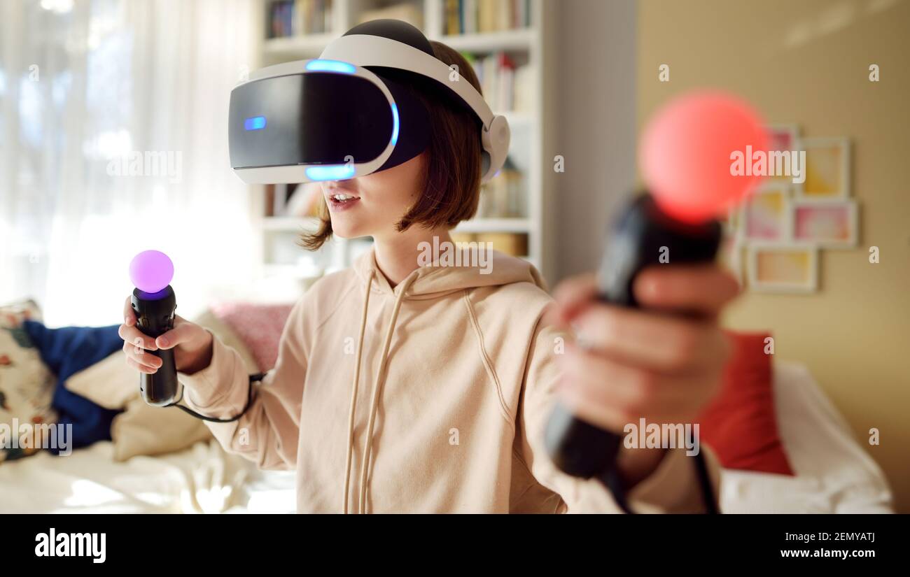 Pretty teenage girl wearing virtual reality headset at home. Cute teen ...