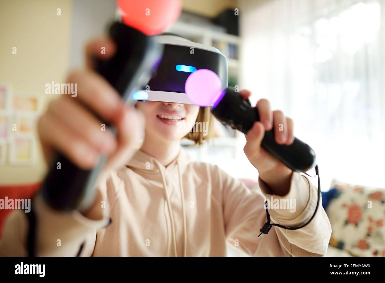 Pretty teenage girl wearing virtual reality headset at home. Cute teen ...