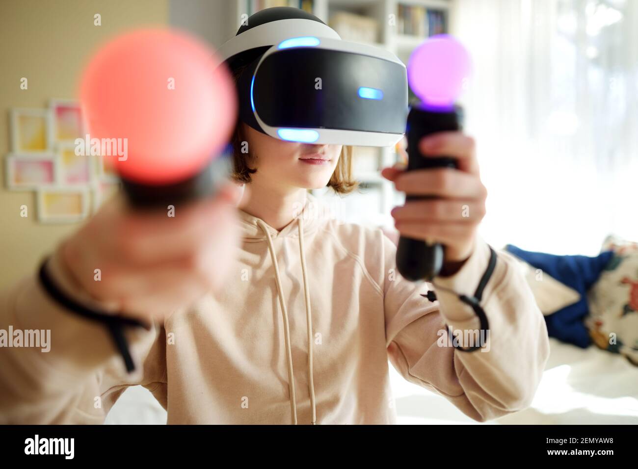 Pretty teenage girl wearing virtual reality headset at home. Cute teen ...