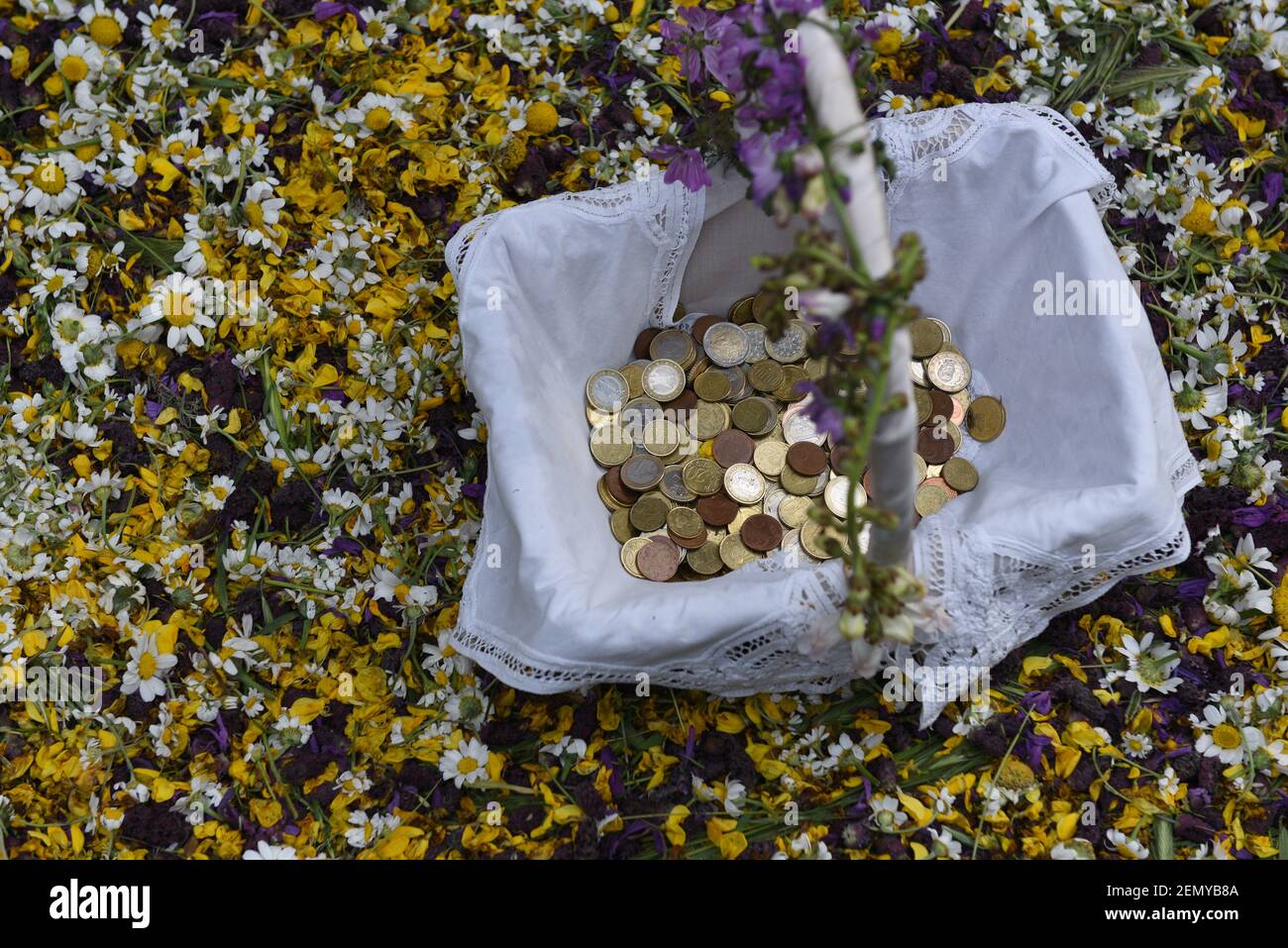 Flowers and coins are seen in an altar during the traditional ...