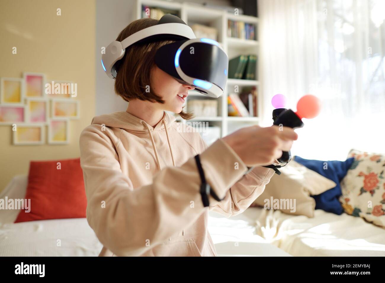 Pretty teenage girl wearing virtual reality headset at home. Cute teen ...