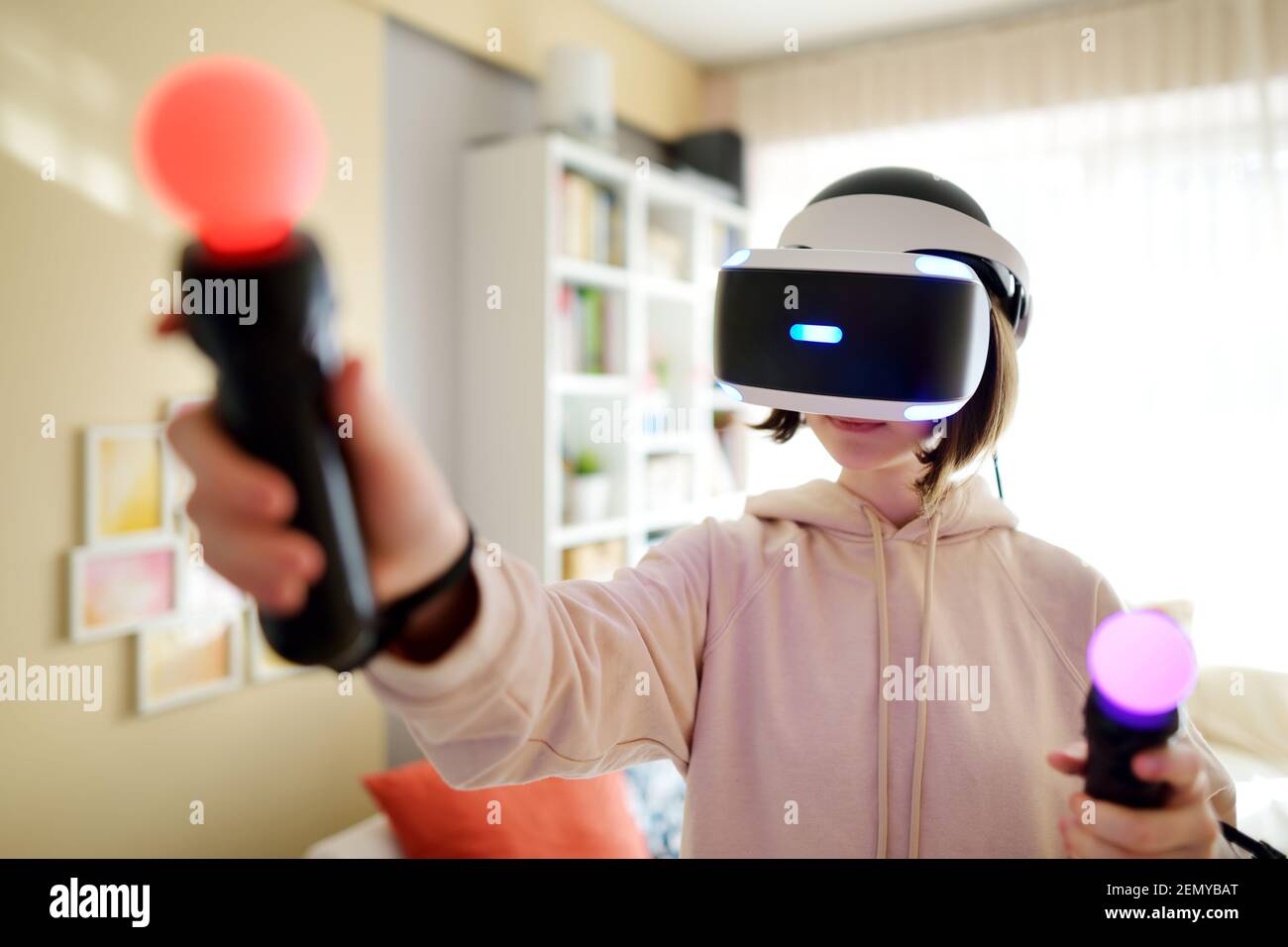 Pretty teenage girl wearing virtual reality headset at home. Cute teen ...