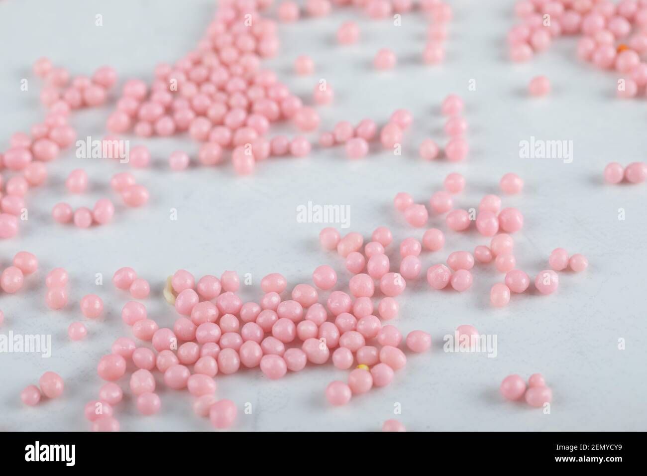 Bunch of pink candies on white background Stock Photo - Alamy