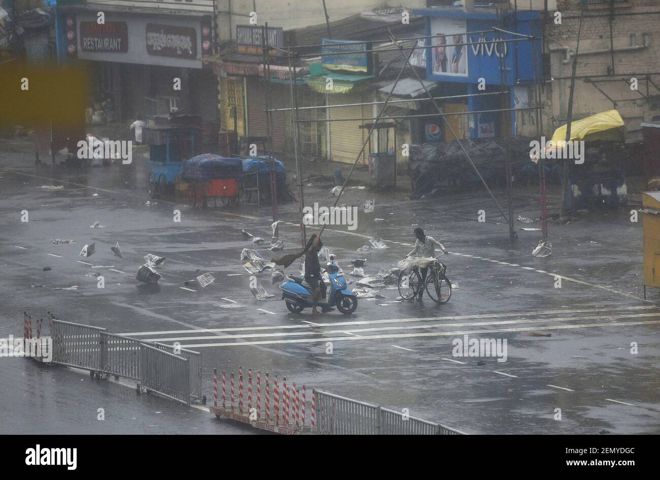 PURI, INDIA - MAY 3: A newspaper vendor looks on as all the papers are ...
