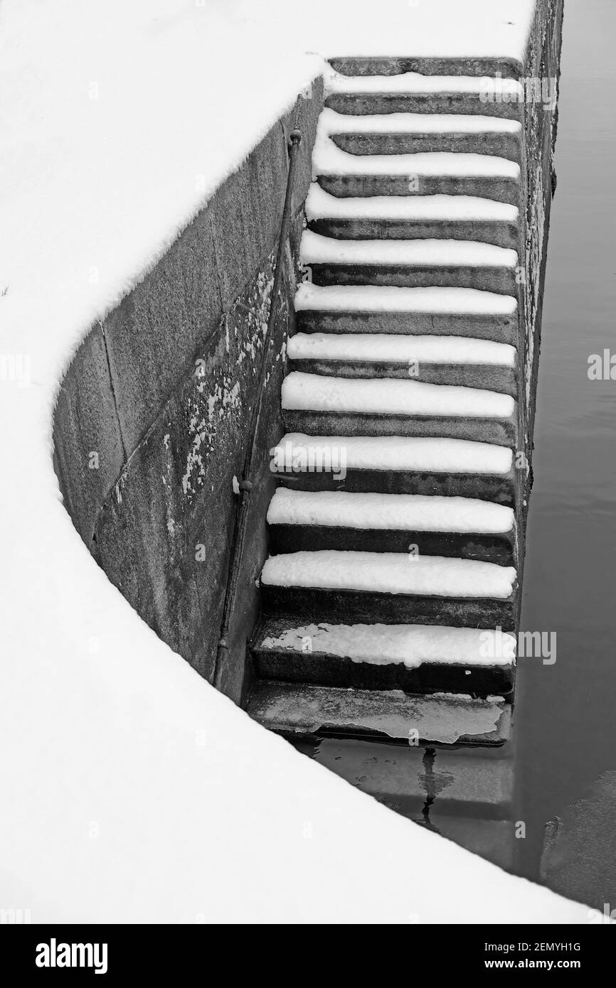 Snow covered frozen steps and water in North Shields Royal quays marina ...