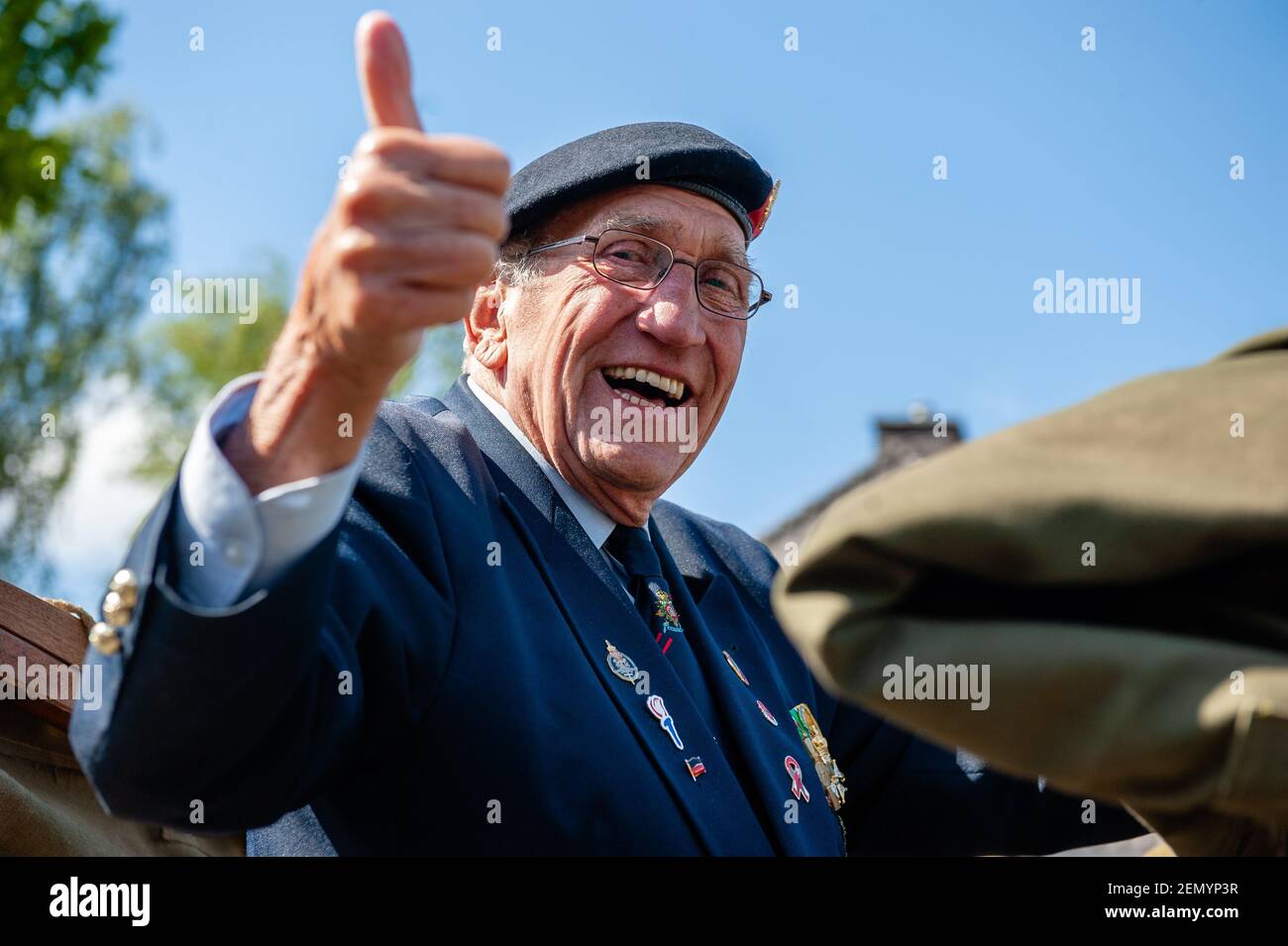 A WWII veteran is seen giving a thumbs up to the camera during the ...