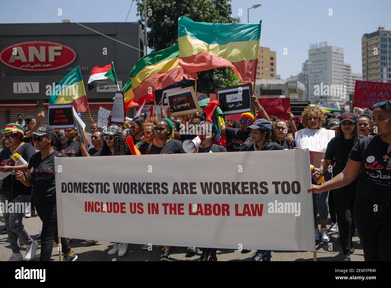 Protesters are seen holding a banner, flags and placards during the ...