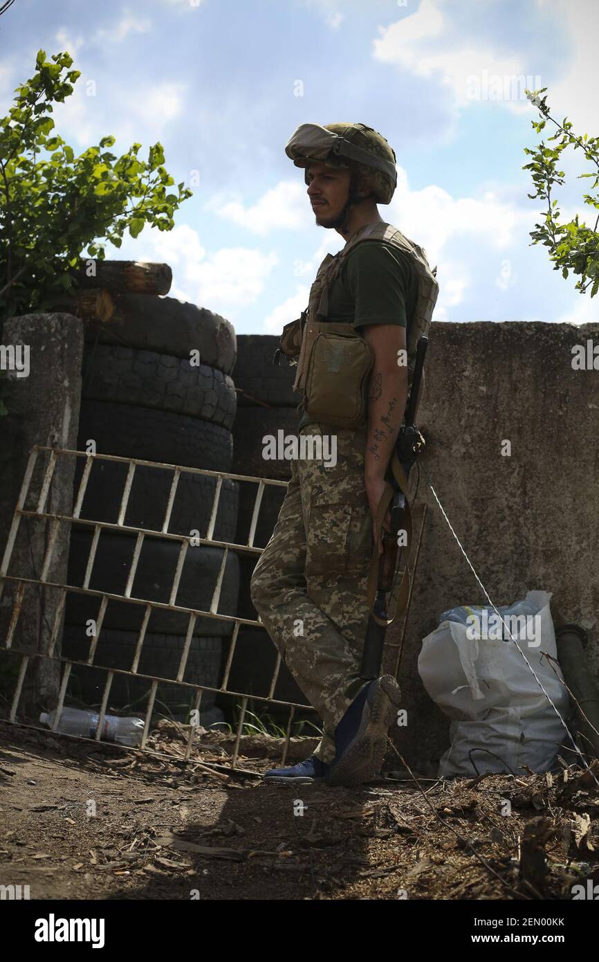 A Ukrainian soldier holds an AK-74 fitted with a silencer in the ...