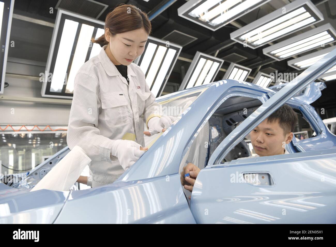 Chinese workers assemble vehicles on the assembly line at the auto ...