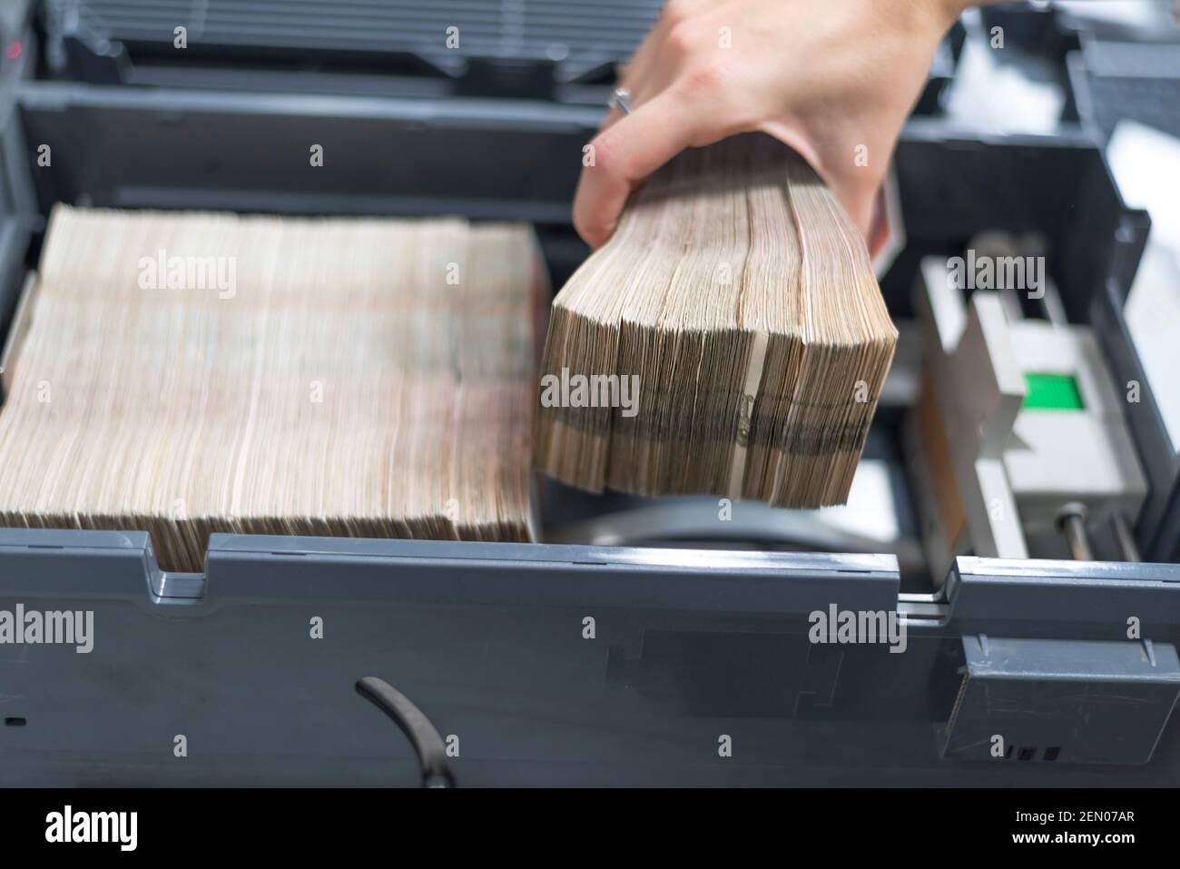 Bank employees sorting and counting money inside bank vault. Large ...