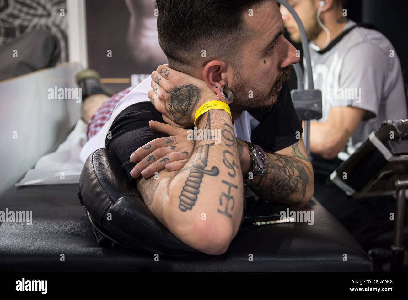 A tattoo artist seen working on a customer during the International ...